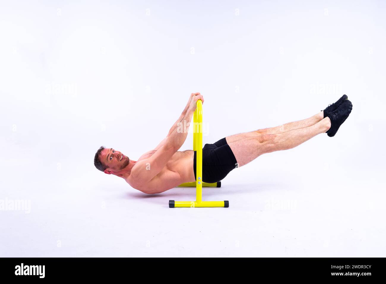Male gymnast performing handstand on a parallel bars, studio shot Stock ...