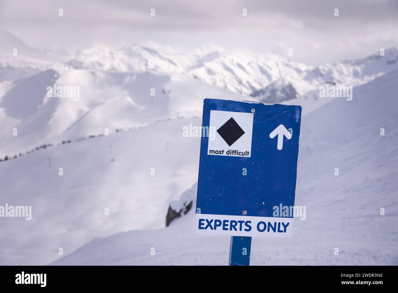 Downhill skiers on Whistler Mountain, expert only ski run sign, ski ...