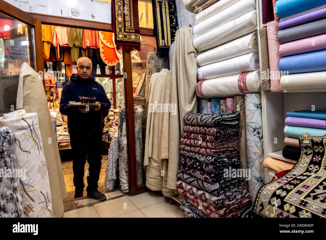 Carpets fabrics shop store, man entering with traditional Turkish tea ...