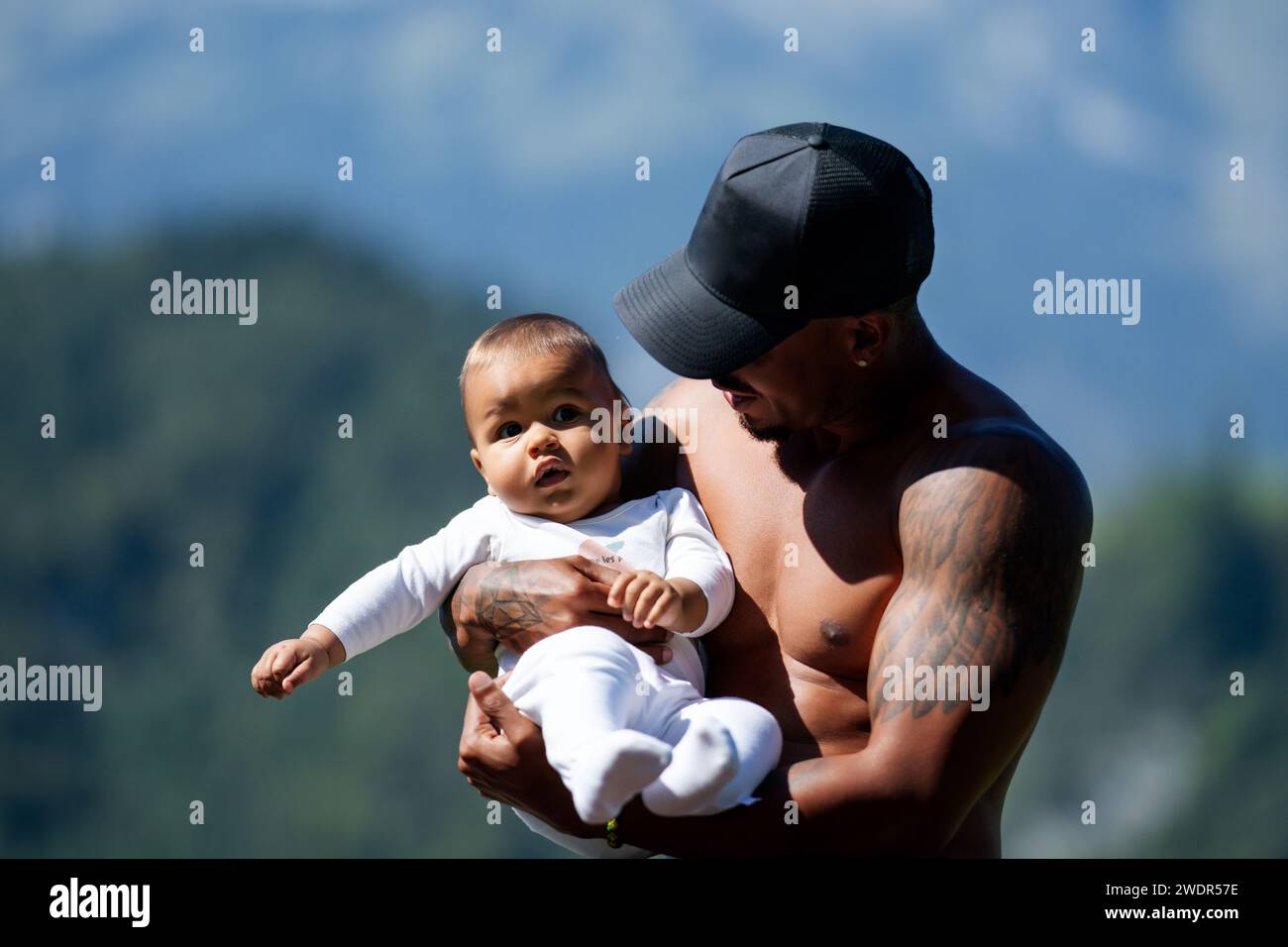 Close up portrait of afro american father kissing multiracial Biracial ...