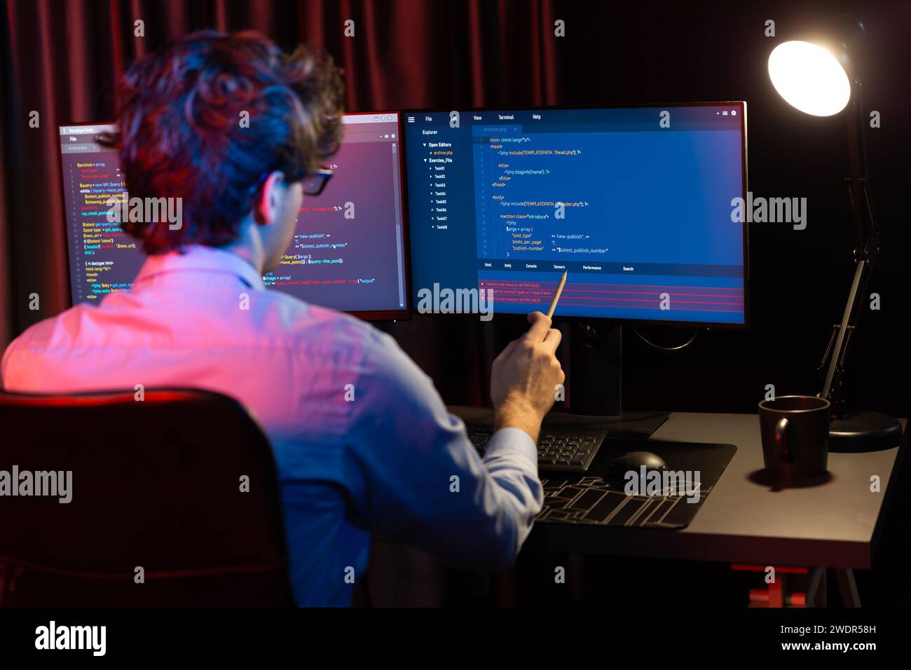 Working IT developer concentrating online software development information on surrounded by ...