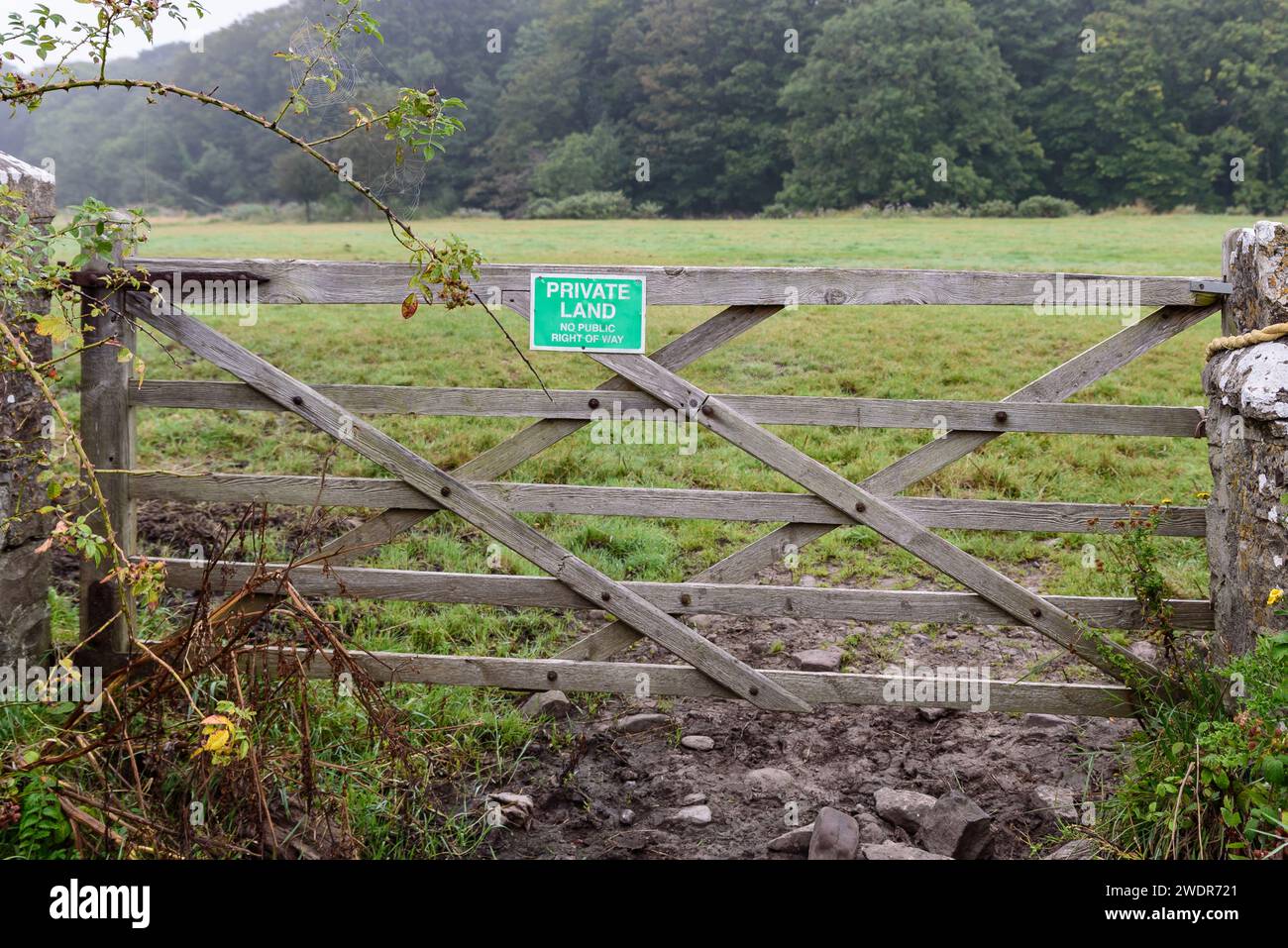 Wooden gate, leading to a rural field. The gate has a sign stating ...