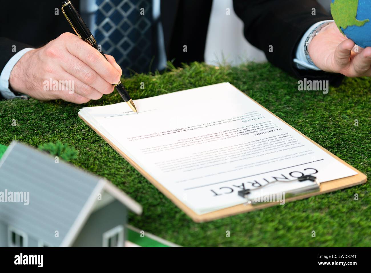 Businessman or CEO in office signing environmental regulation agreement ...