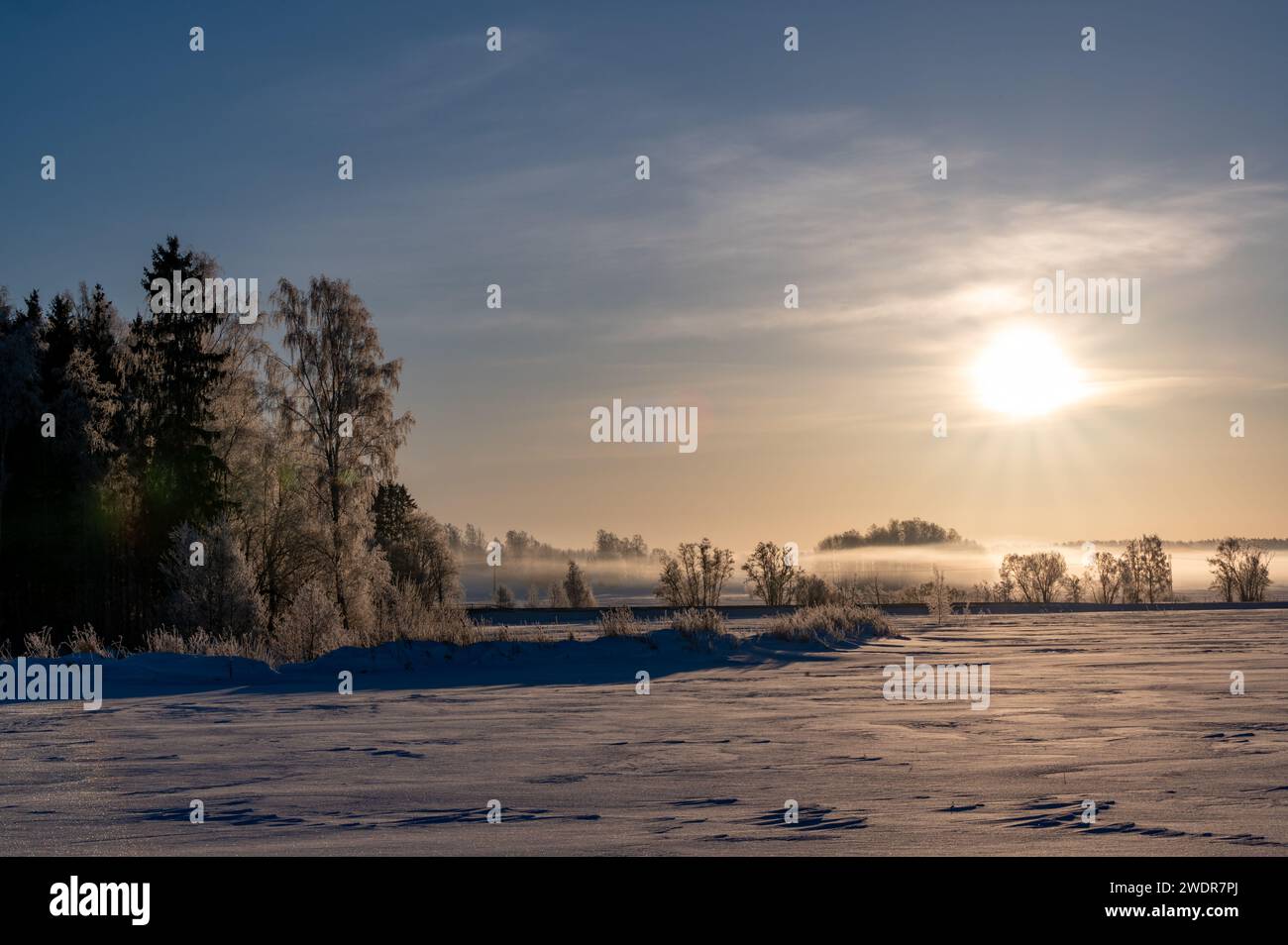 Sunshine over open fields covered in snow Stock Photo - Alamy