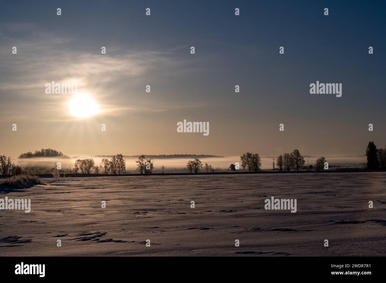 Sunshine over open fields covered in snow Stock Photo - Alamy