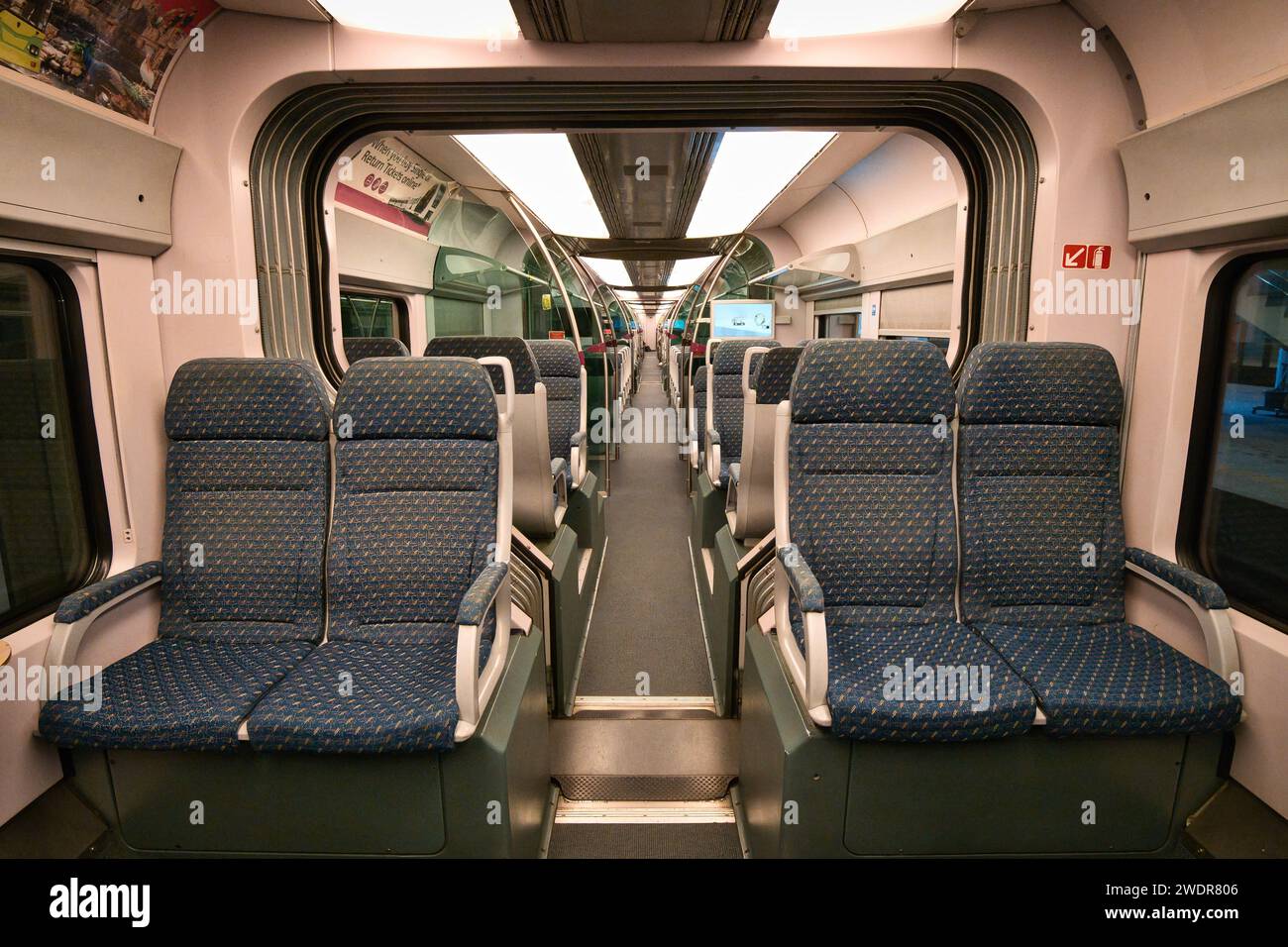 Inside of an empty train cabin with windows showing it is dark outside ...