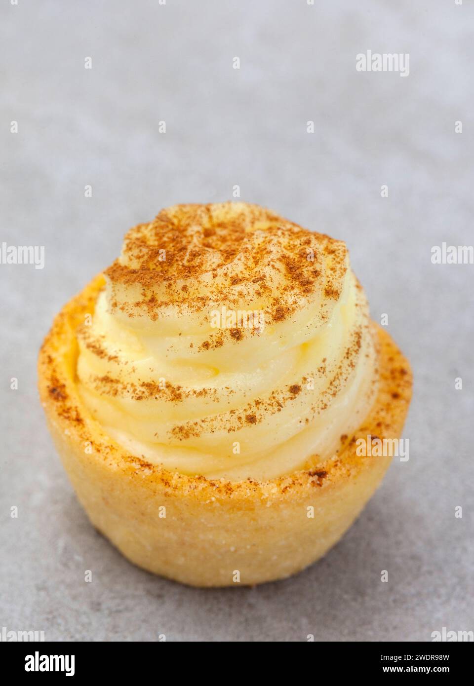 Mini South African milk tart cups on mottled grey with copy space and ...