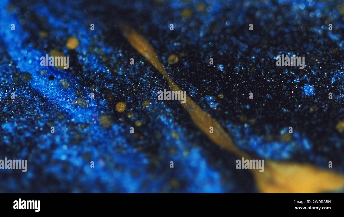 Oil fluid flow glitter texture blue golden paint Stock Photo - Alamy