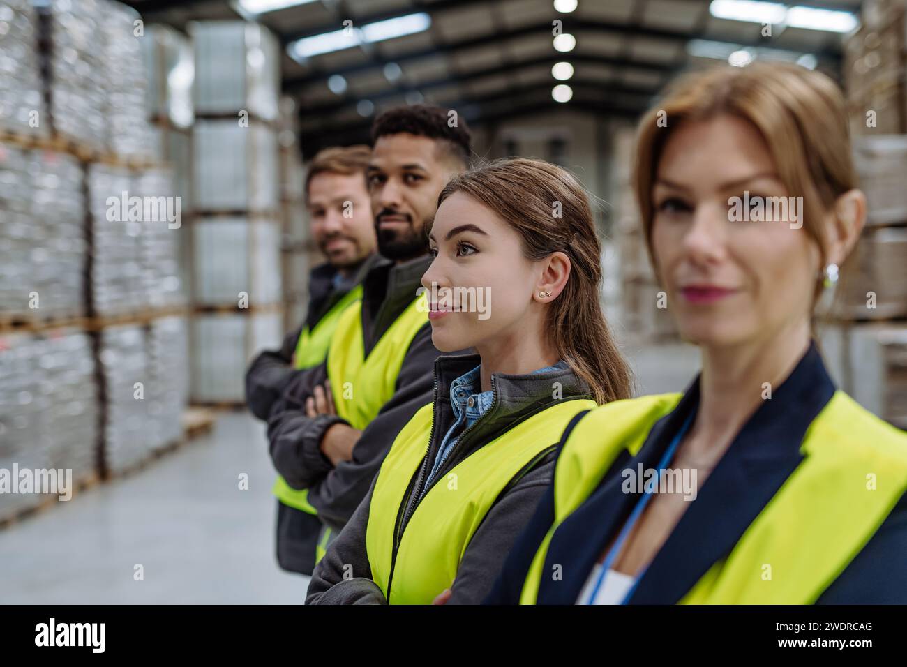 Full team of warehouse employees standing in warehouse. Team of workers ...