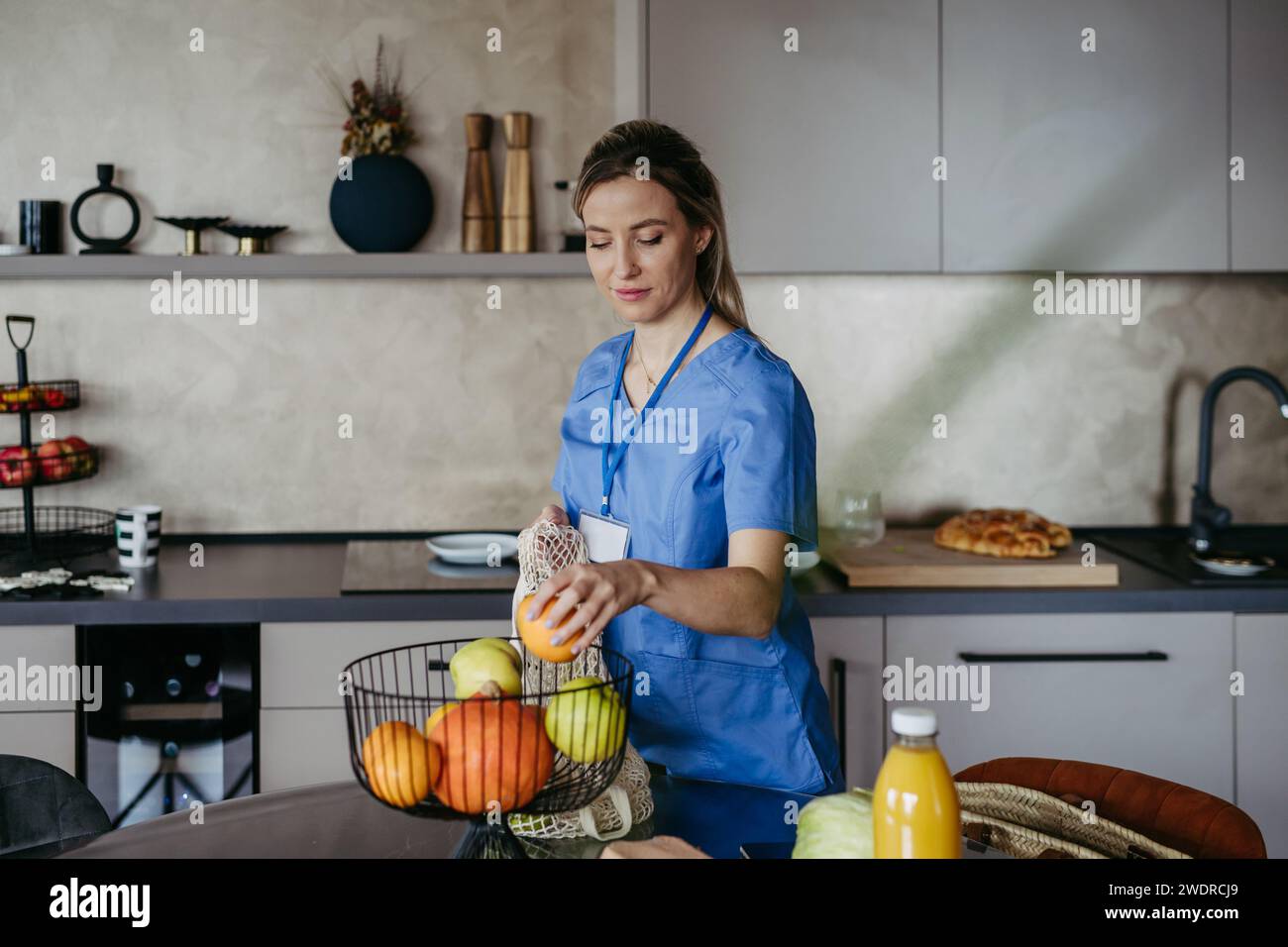 Female nurse returning home from work with groceries for family. Work ...