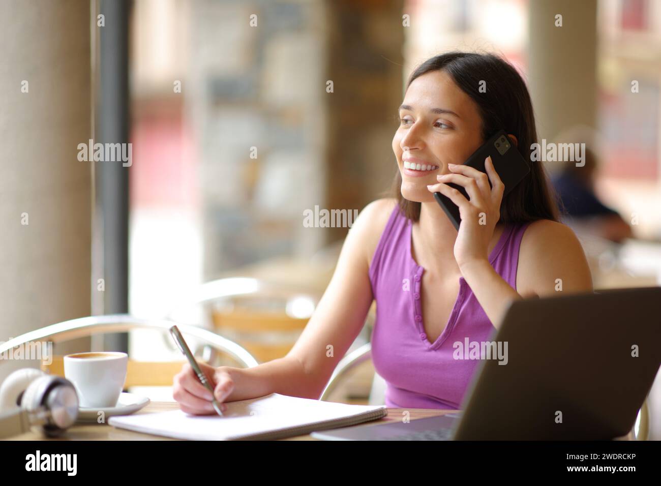Happy student talking on phone e-learning in a bar terrace Stock Photo ...