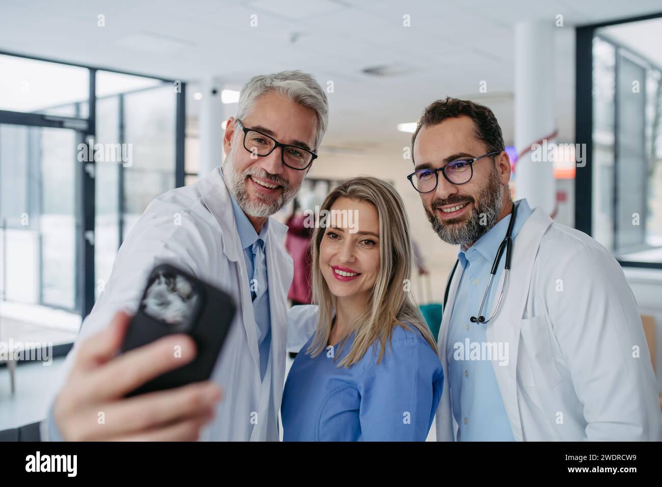 Portrait of doctors and nurse standing in hospital corridor. Healthcare ...