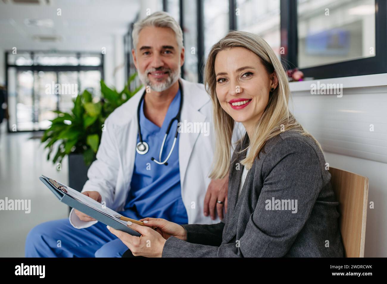 Pharmaceutical sales representative presenting new medication to doctor ...
