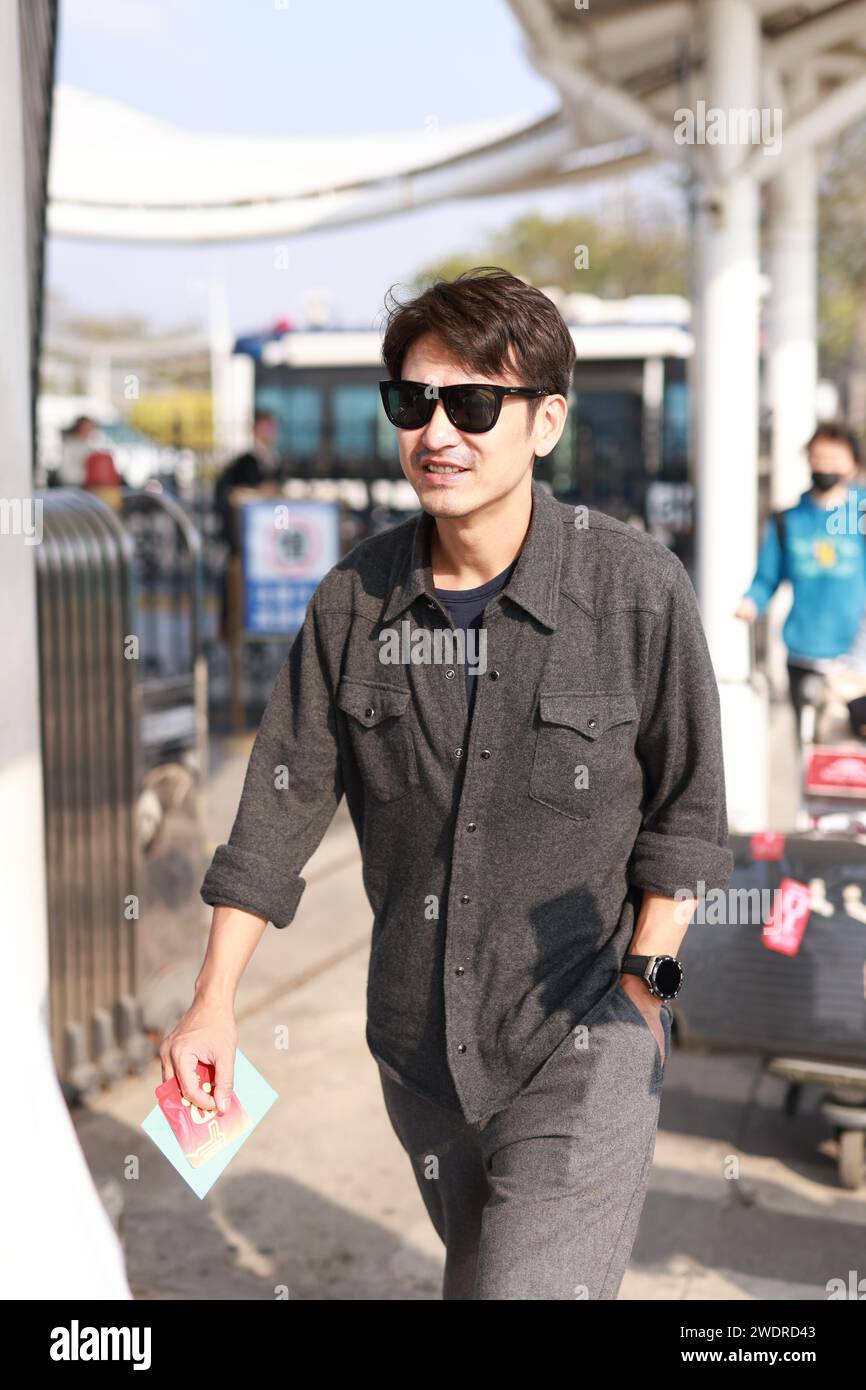 Chinese actor Yuan Wenkang appears at the airport in Guangzhou City, south China's Guangdong ...