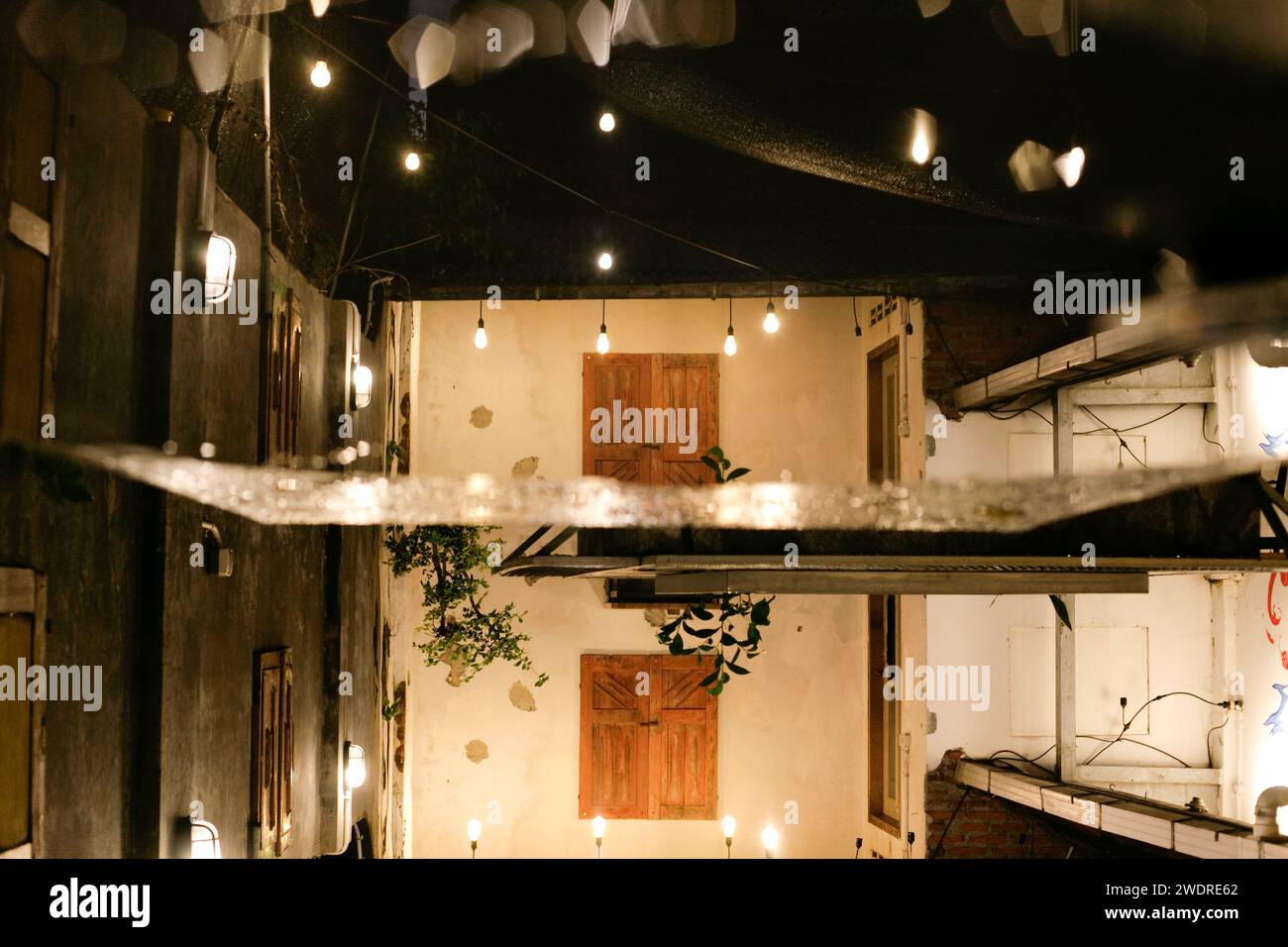 water reflection of rain puddle on the table outside cafe after heavy ...