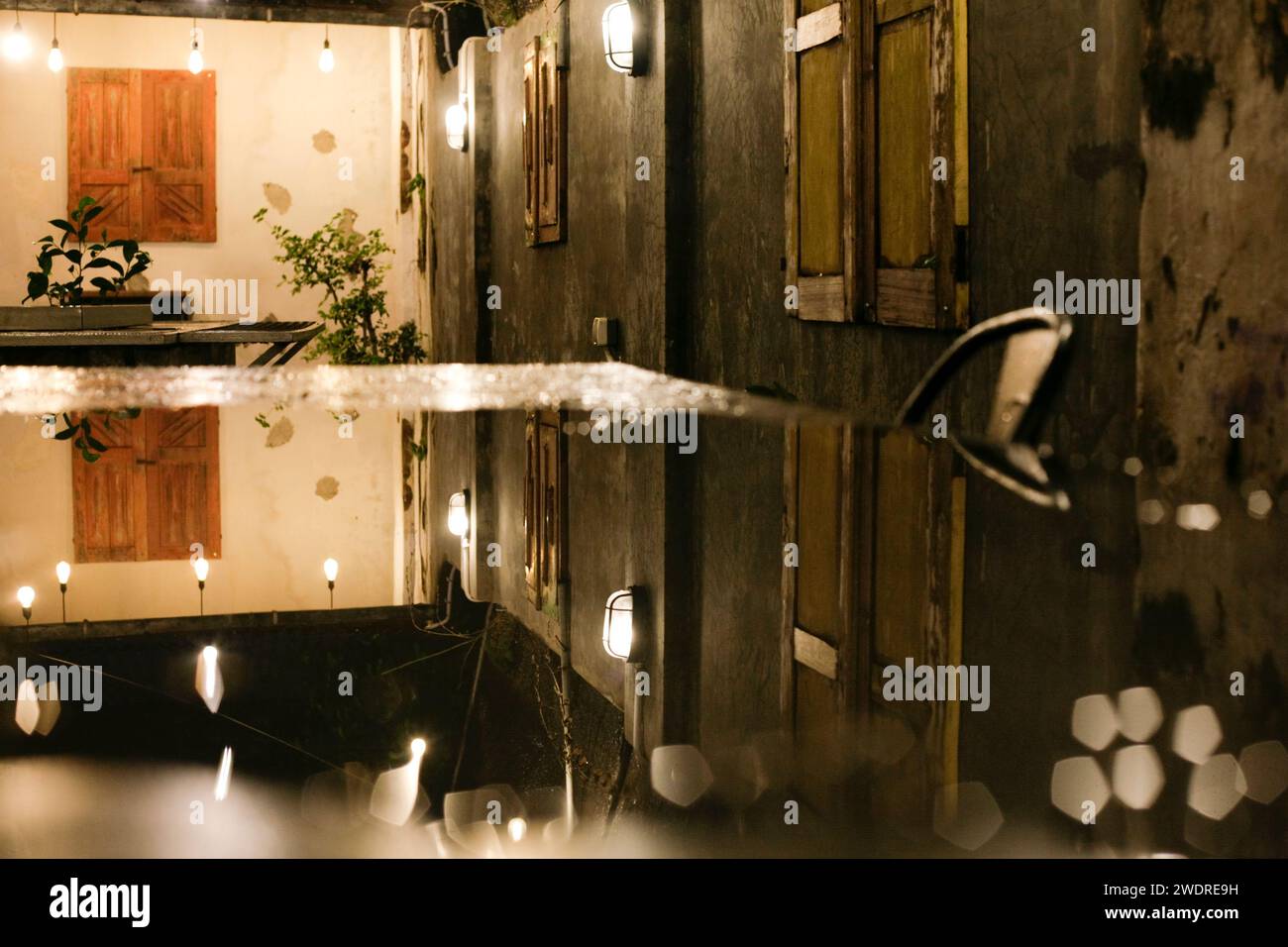 water reflection of rain puddle on the table outside cafe after heavy ...