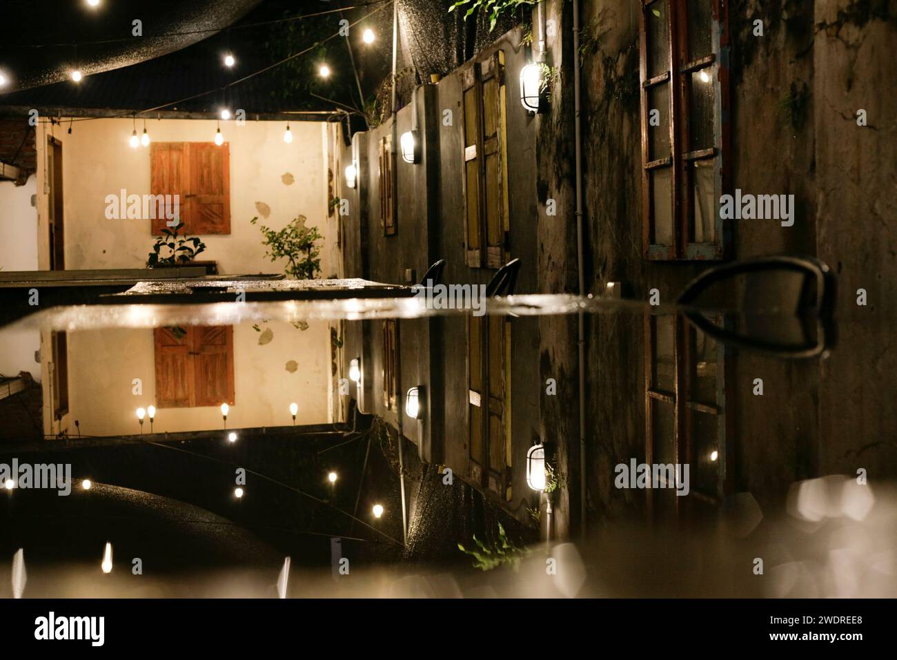 water reflection of rain puddle on the table outside cafe after heavy ...
