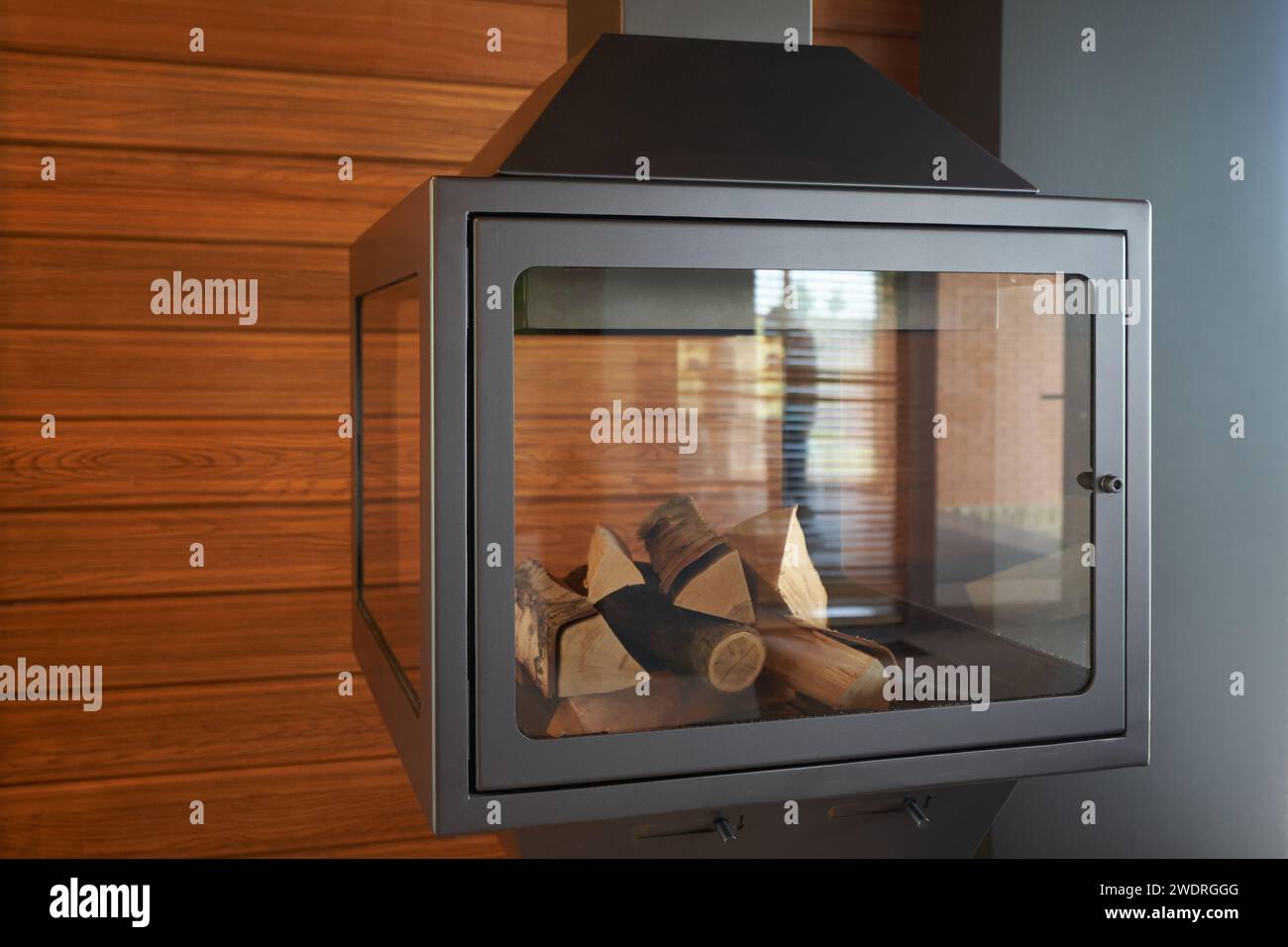 Suspended transparent fireplace in a interior Stock Photo - Alamy