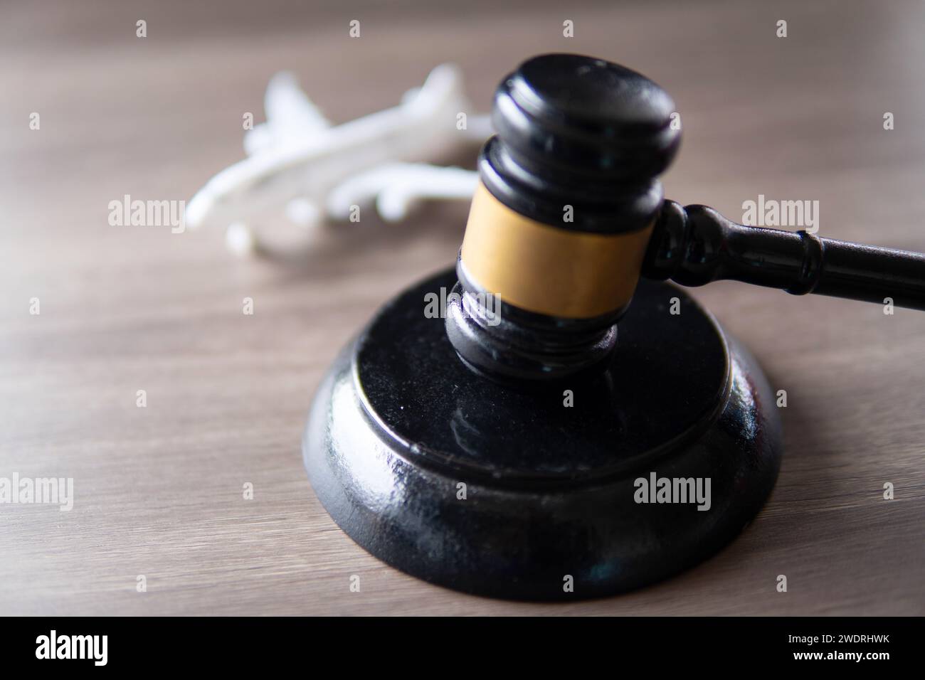 Closeup image of judge gavel and toy plane on table. Aviation law ...