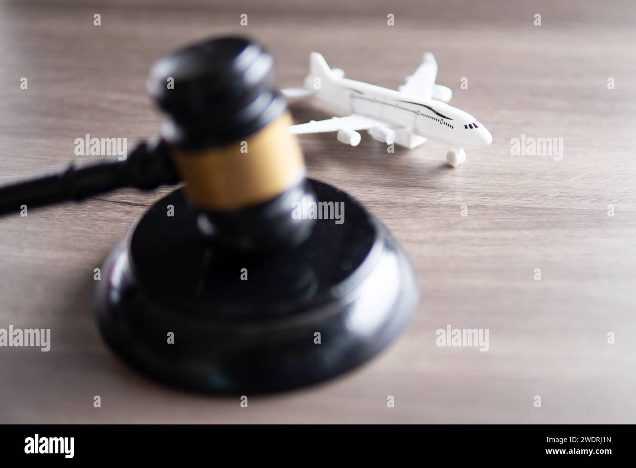 Closeup image of judge gavel and toy plane on table. Aviation law ...