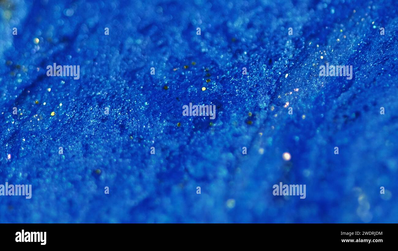 Wet glitter spill gel drip blue golden emulsion Stock Photo - Alamy