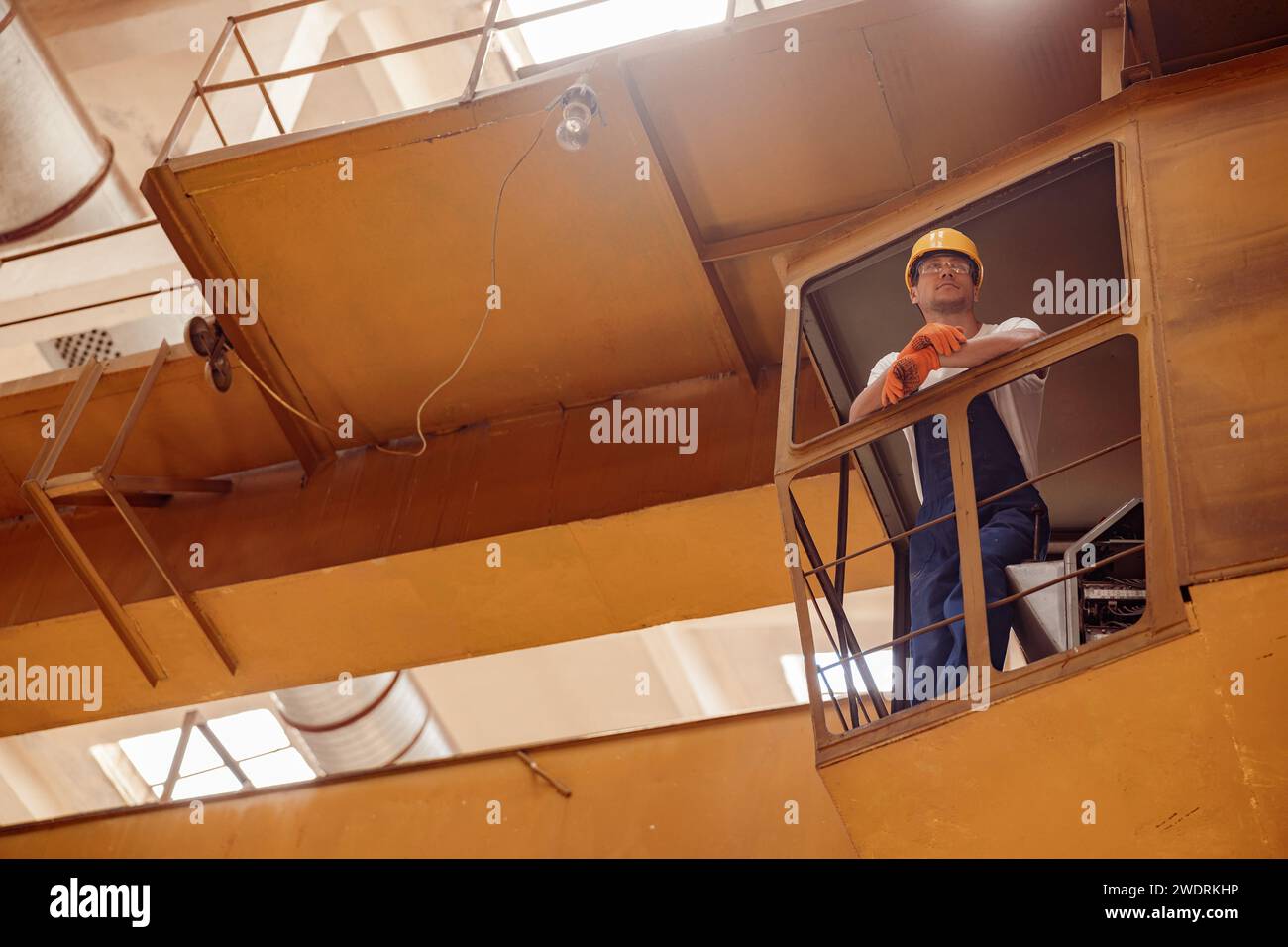 Handsome man builder sitting in operator cabin of overhead crane Stock ...
