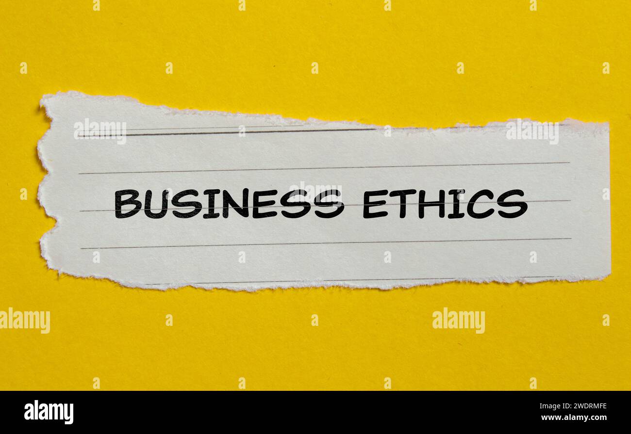 Business ethics lettering on ripped paper piece with yellow background ...