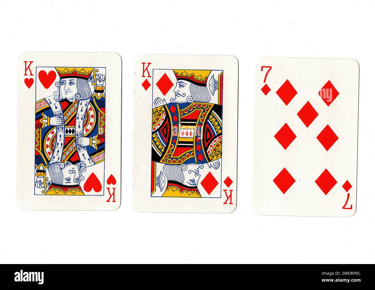 Vintage playing cards showing a pair of red kings and a red seven ...