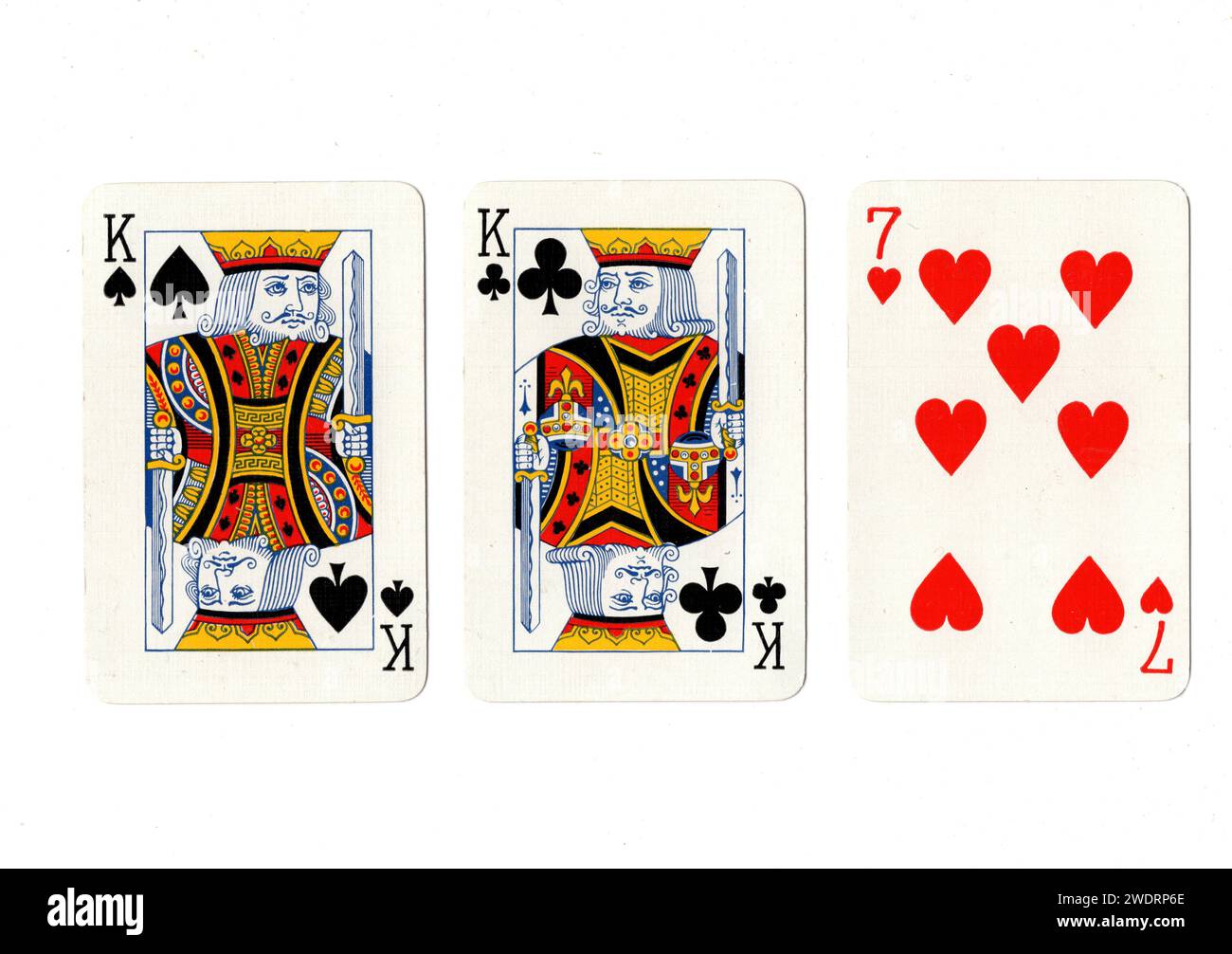 Vintage playing cards showing a pair of black kings and a red seven ...