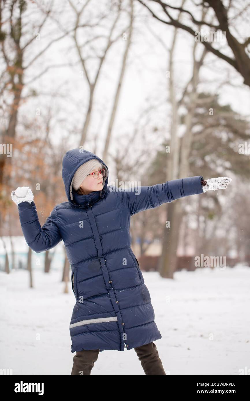 The girl throws a snowball Stock Photo - Alamy