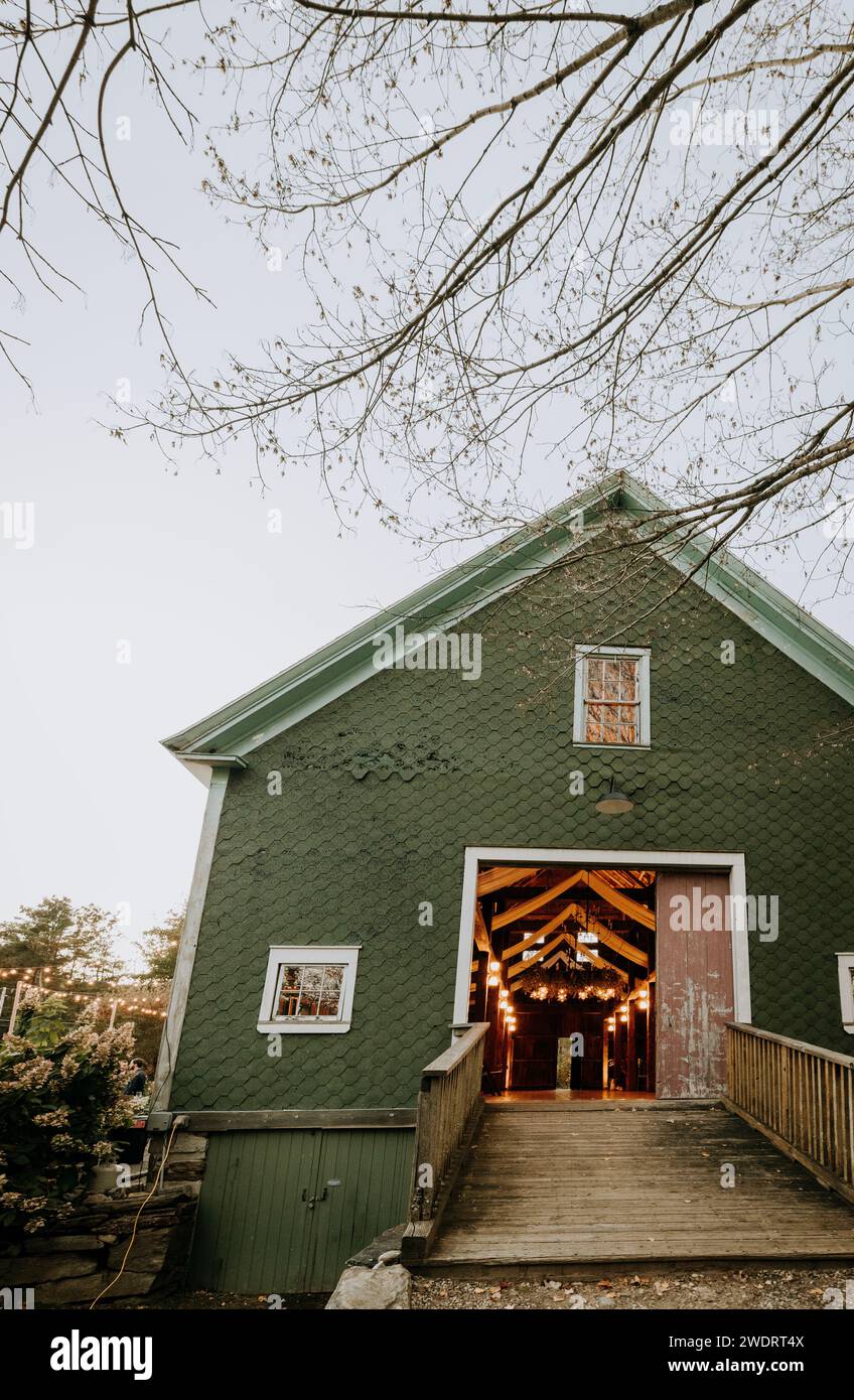 Barn with barn door open glowing with lights for wedding reception ...