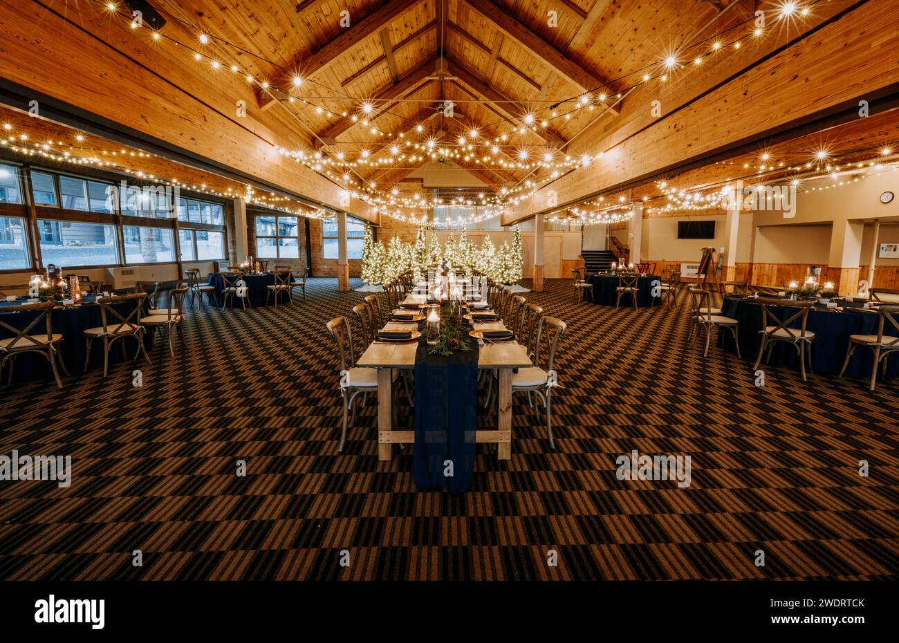 large room set up for wedding reception with dinner tables Stock Photo ...