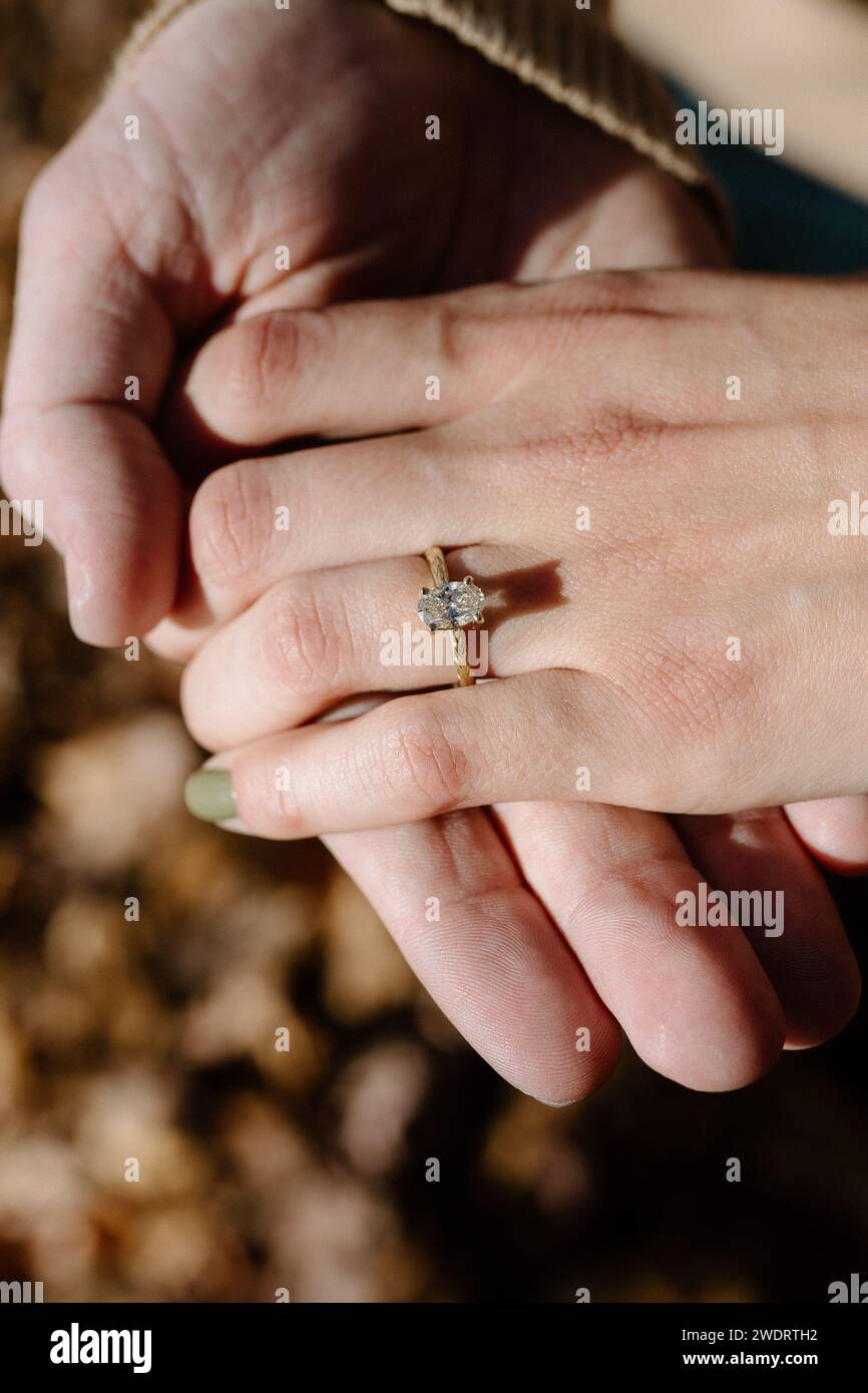 engaged couple showing diamond ring with gold band after proposal Stock ...
