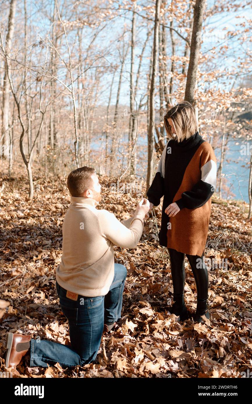 fall proposal while hiking in the woods near a lake Stock Photo - Alamy