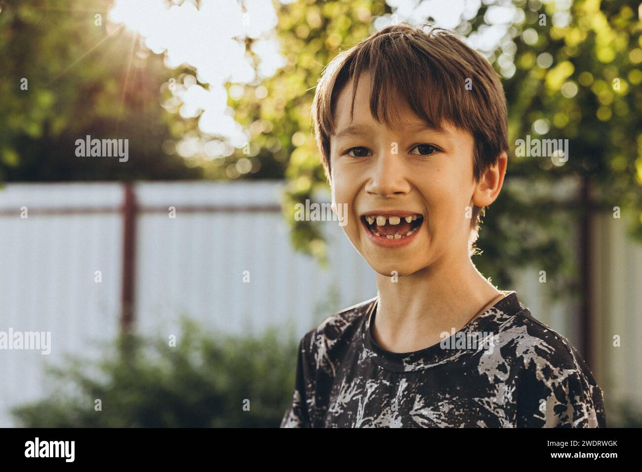 Portrait of a smiling boy on the street on a summer’s day Stock Photo ...