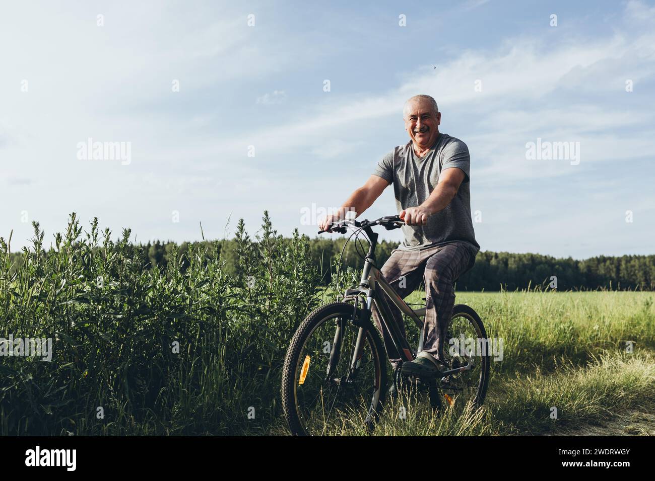 Senior male riding bike hi-res stock photography and images - Alamy