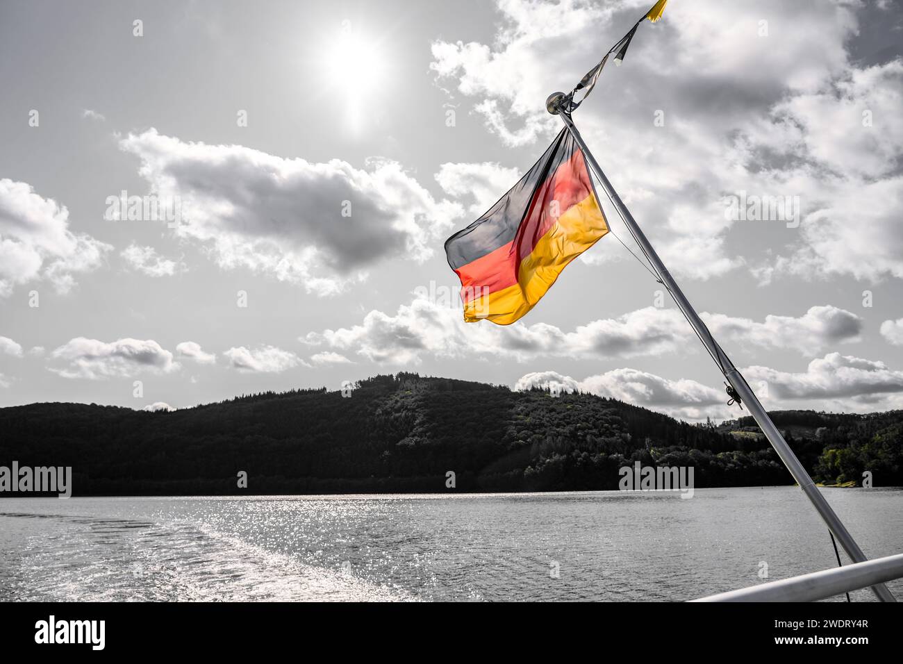 Colored German flag on a boat in front of a black and white background ...