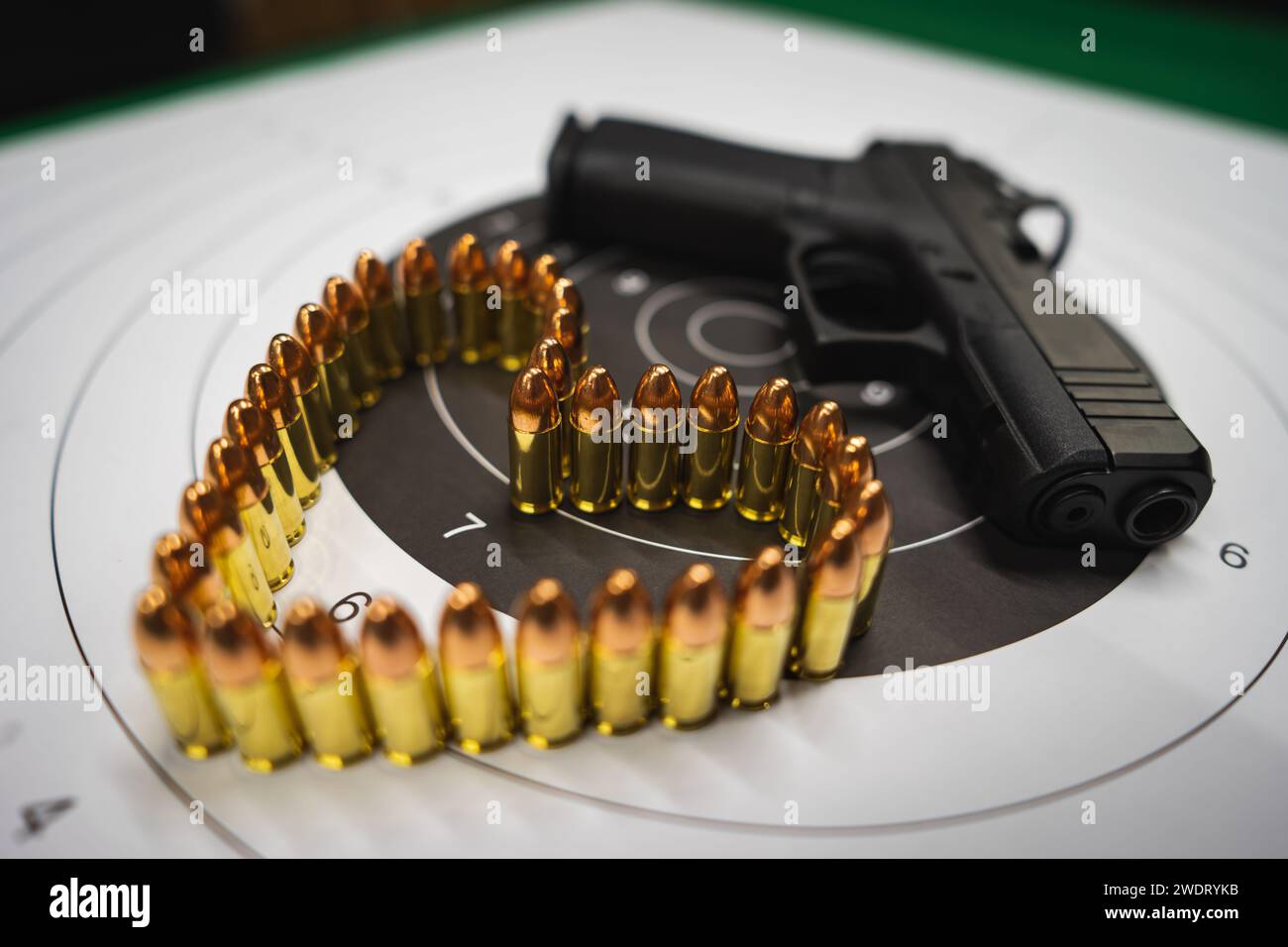 Theme of Valentine's day and weapons. A modern compact pistol g43x, a target and a heart made of ...