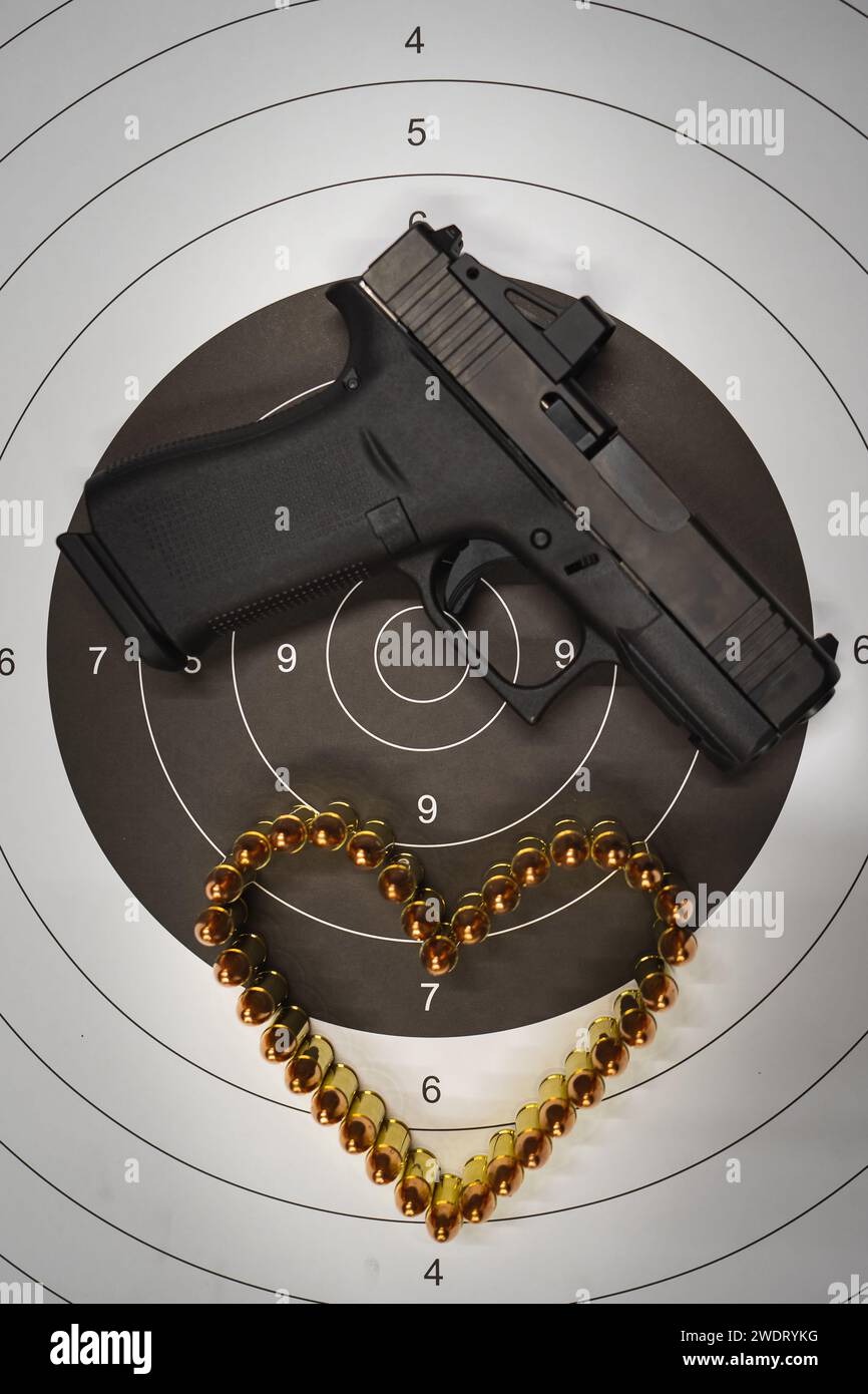 Theme of Valentine's day and weapons. A modern compact pistol with a ...