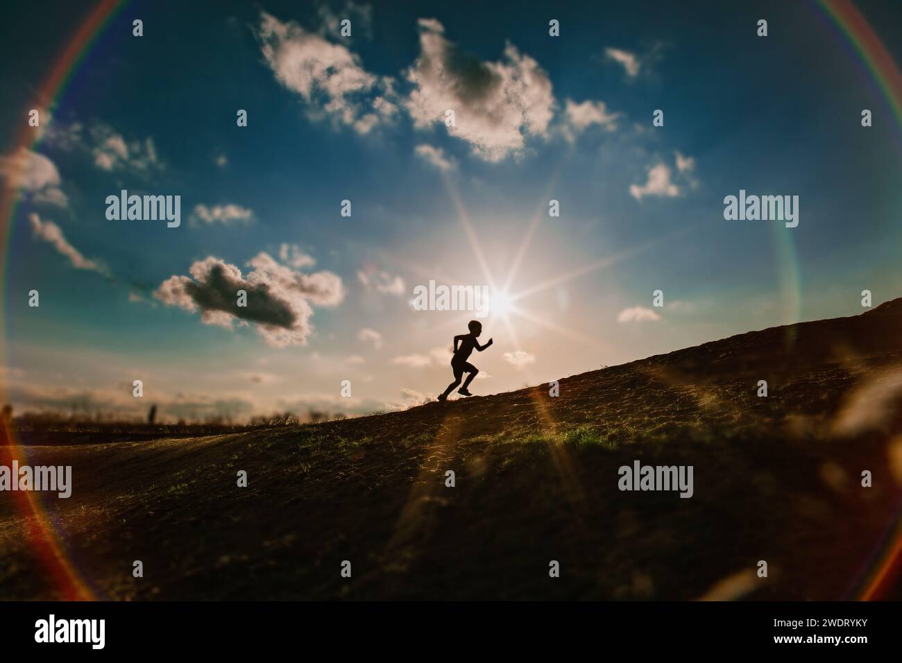 Boy Running Uphill with blue sky and clouds Stock Photo - Alamy