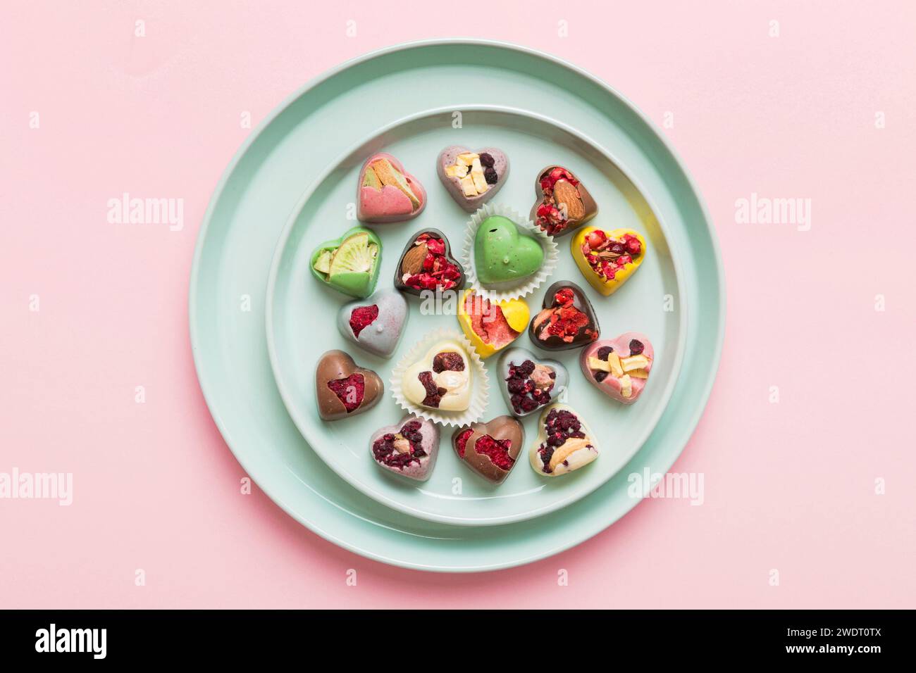 Plate with different chocolate on colored background. Assortment of ...
