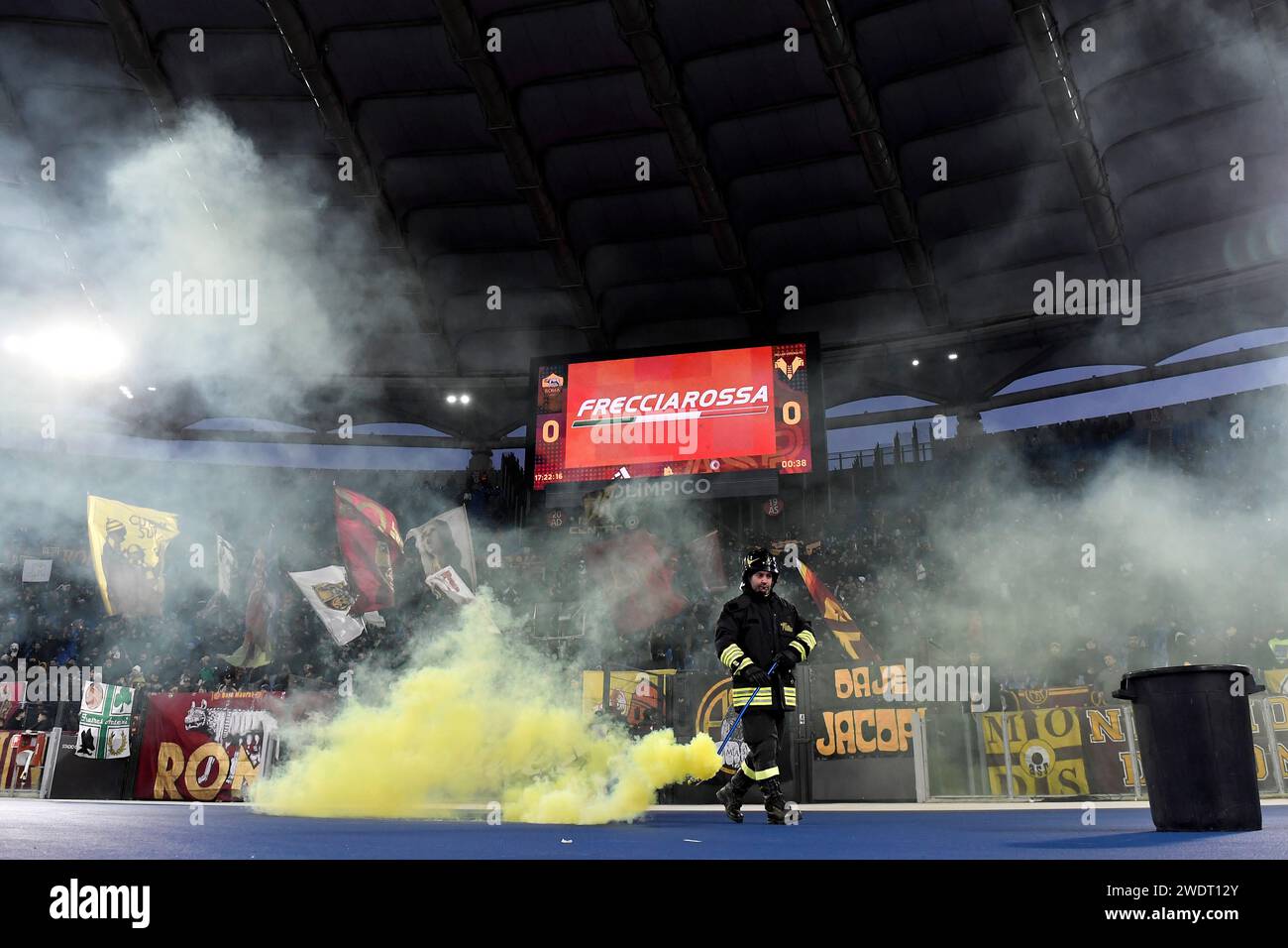 A fireman removes a smoke grenade thrown by roma fans during the Serie ...