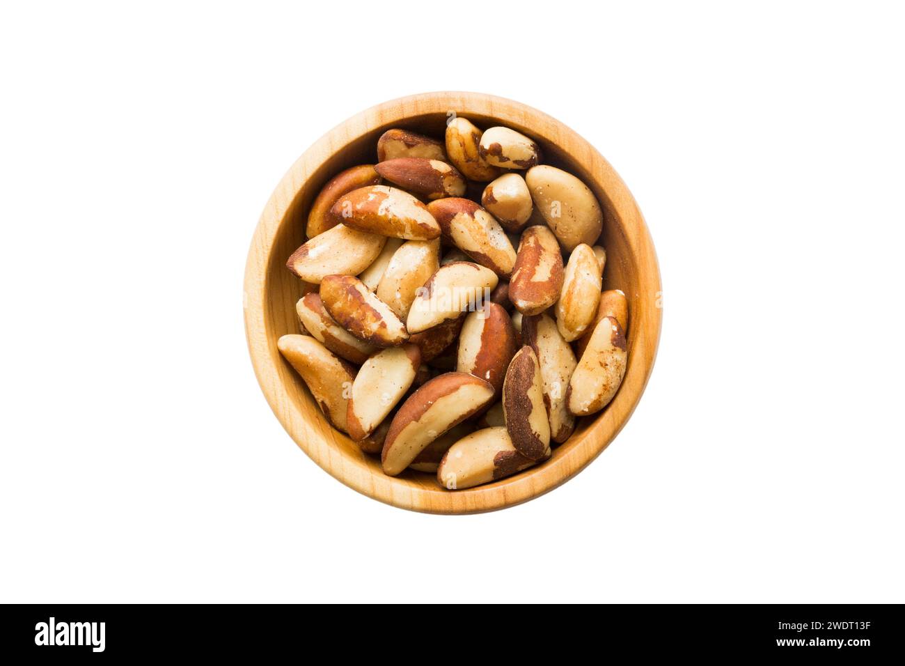 Roasted Brazil nut in bowl isolated on white background. Brazil nut is ...