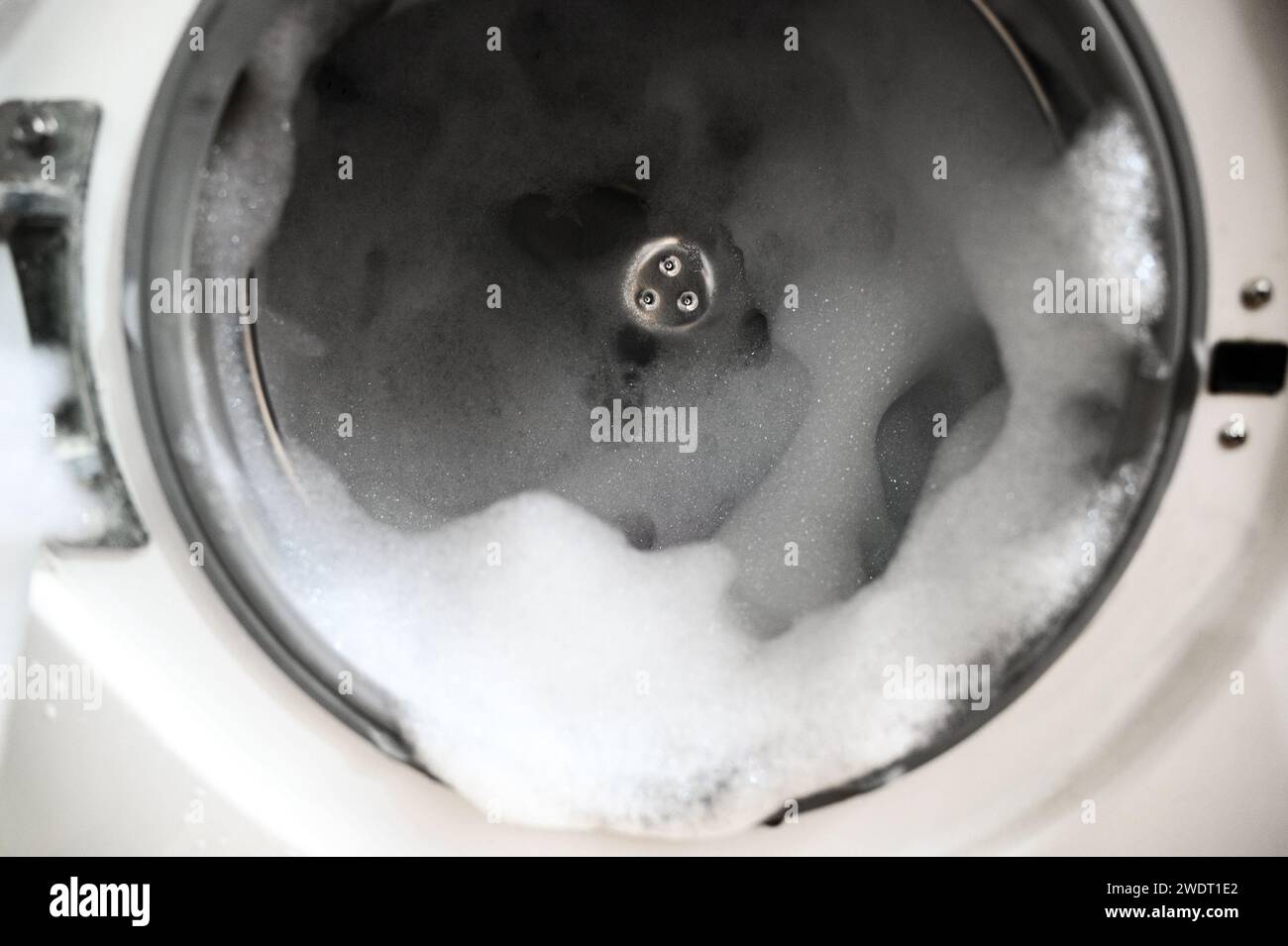 Washing machine with a lot of foam inside. Open lid Stock Photo - Alamy