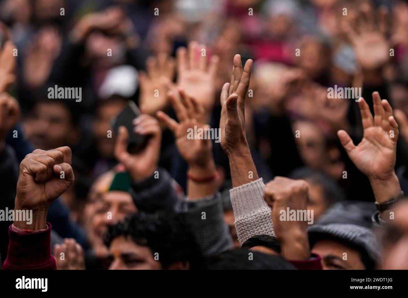Hindu devotees raise their hands as they chant religious hymns at ...