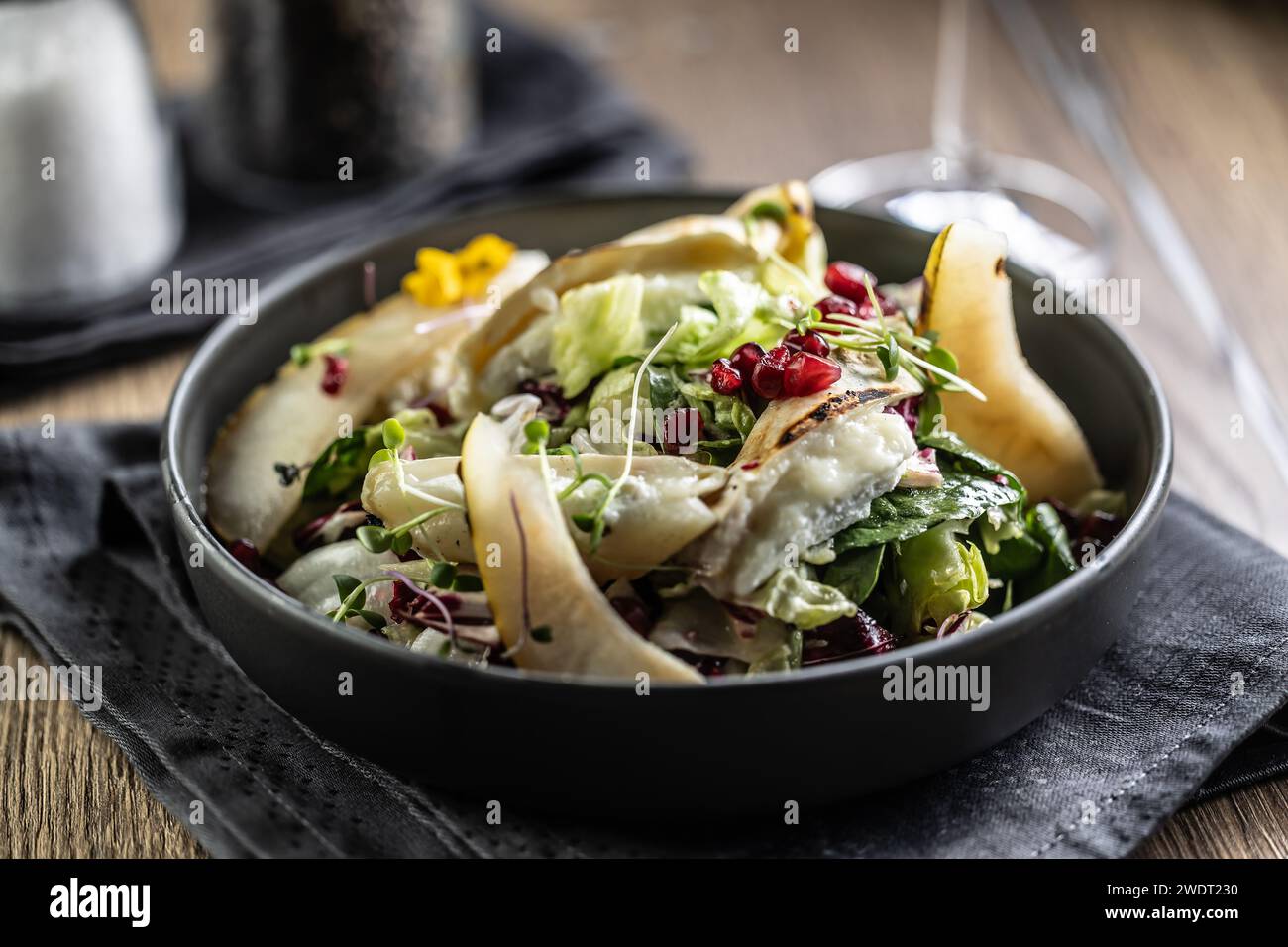 Healthy salad with goat cheese, lettuce, pears and pomegranate Stock ...