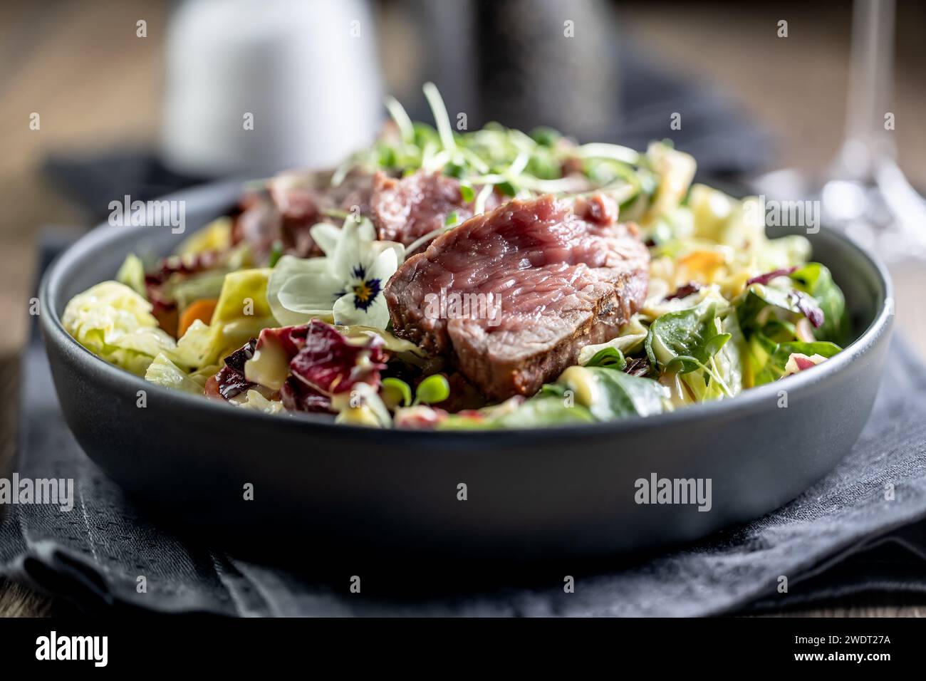 Fillet of beef sirloin with lettuce salad in plate on pub or restaurant ...