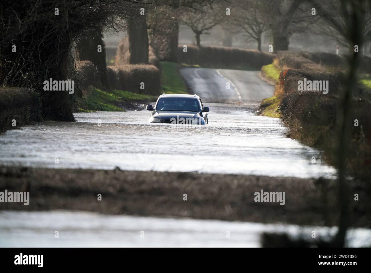 A car driving through flood water in Warwick bridge in Cumbria ...