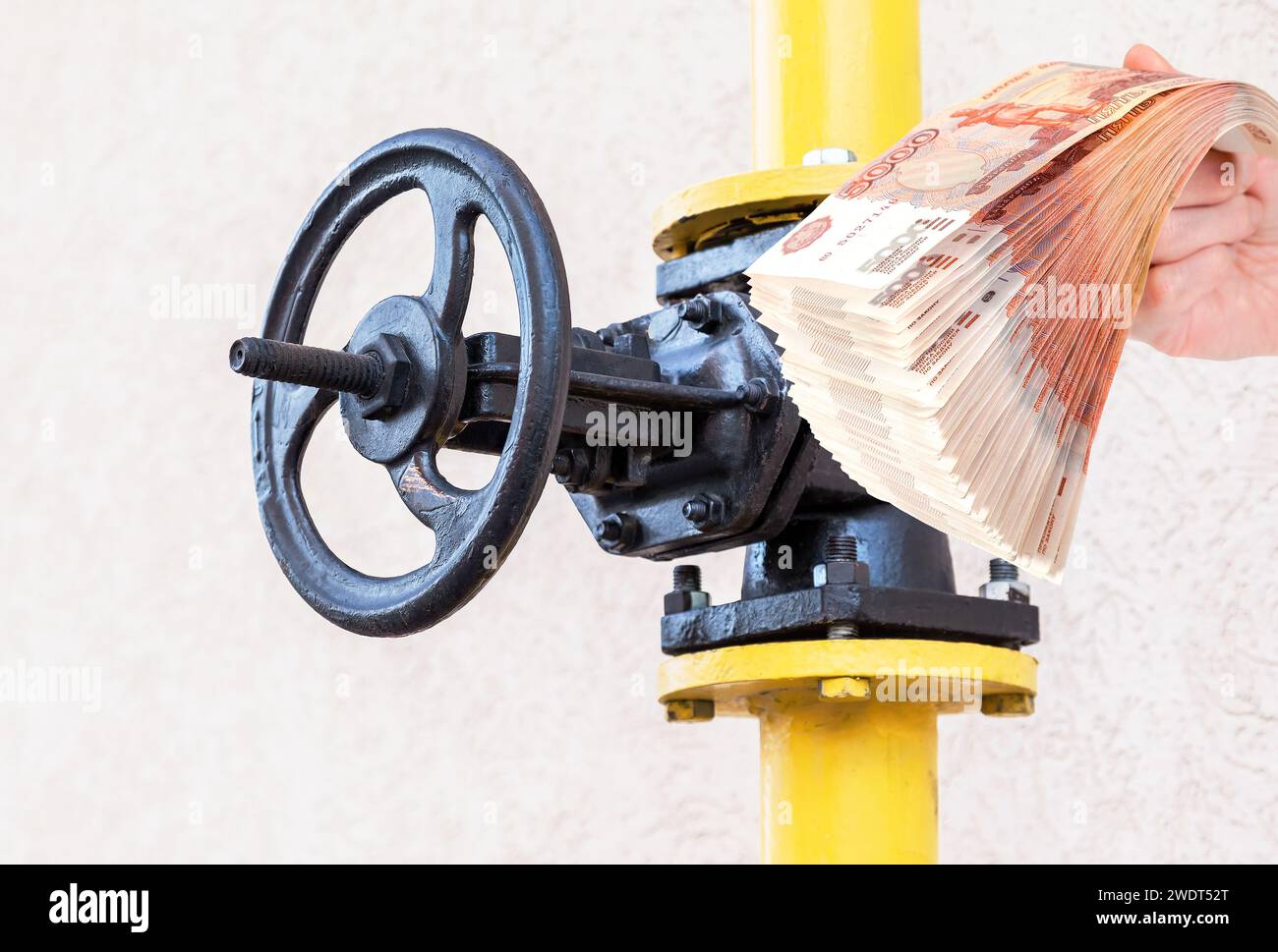 Gas valve on the pipeline of apartment building and ruble bills in the ...