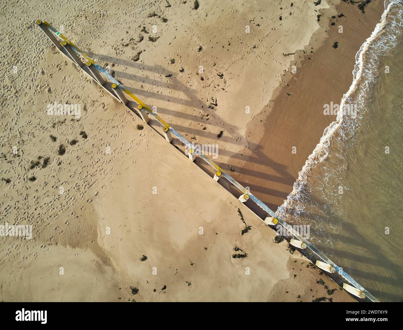 Aerial view of a groyne on the sandy beach at Dawlish Warren, near the ...